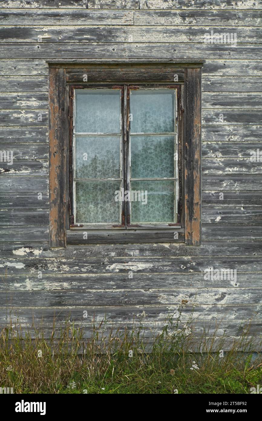 Old wooden window on a dilapidated and run down house with weathered ...