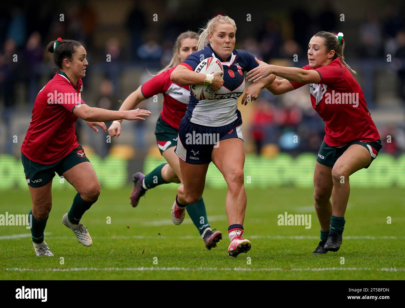 England's Amy Hardcastle (centre) is tackled by Wales' Rhi Parker (left ...