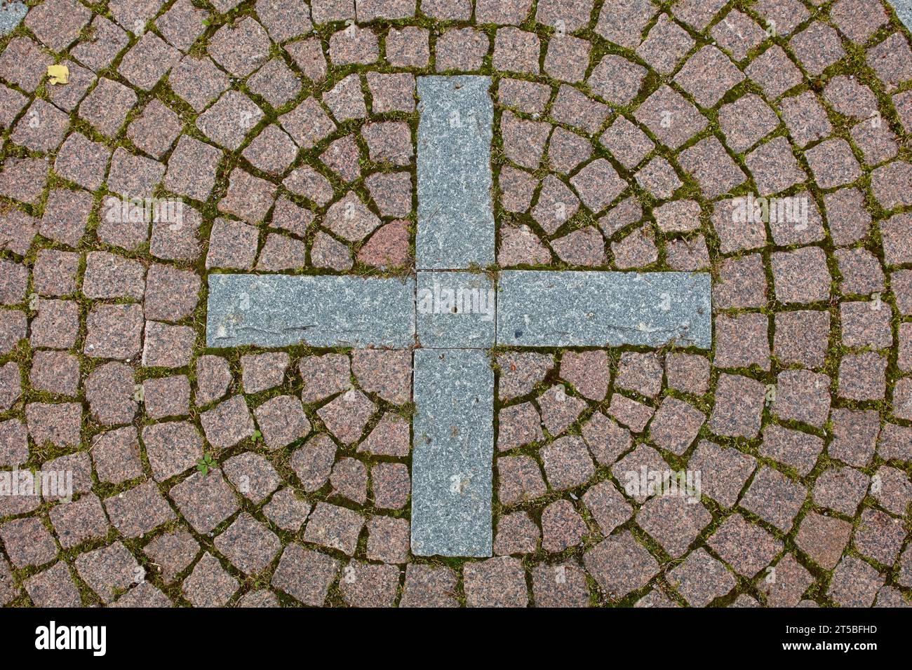 Closeup of cobble stone pavement on ground with a cross Stock Photo - Alamy