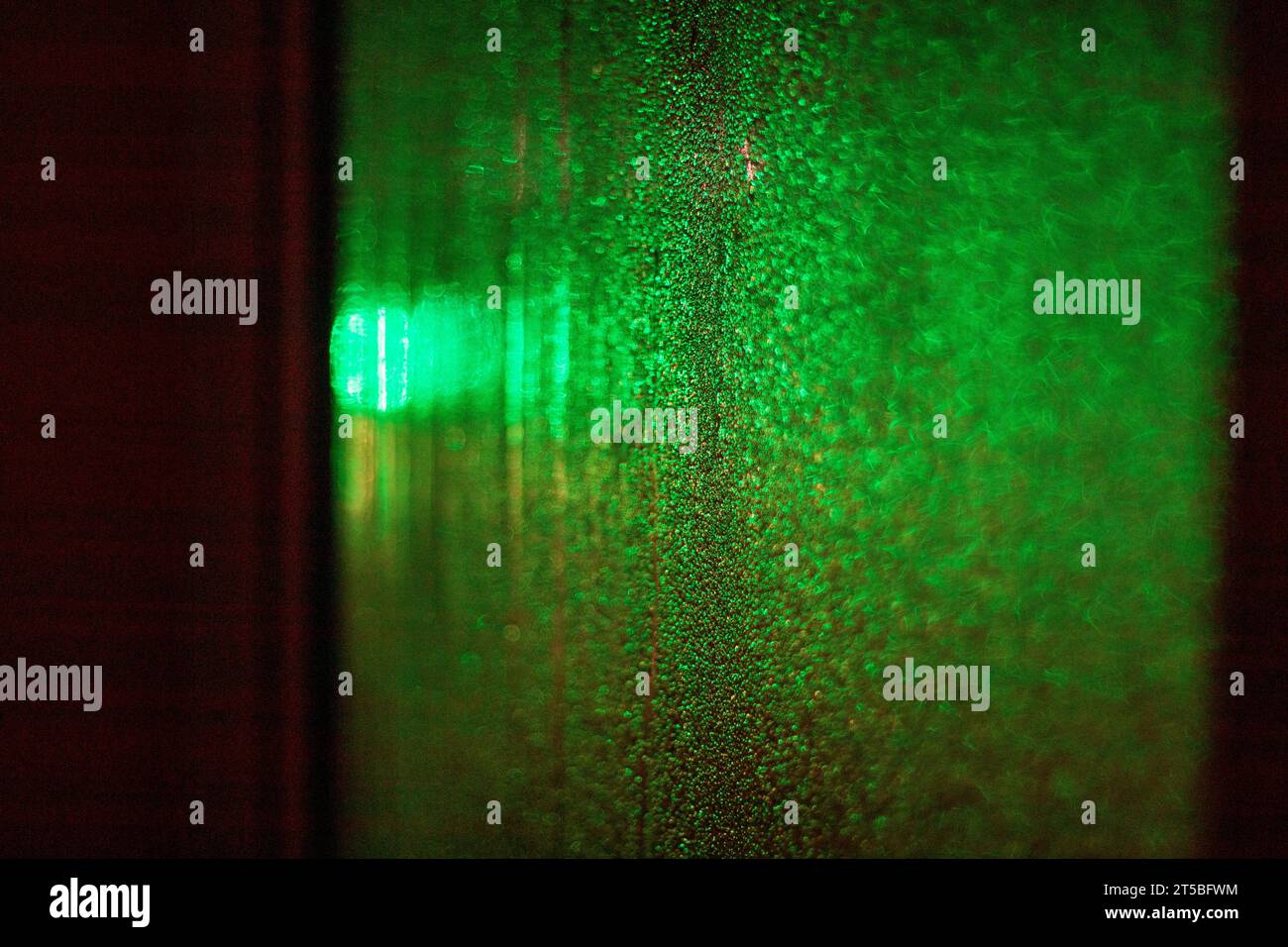 Shot of the window with blurred lights on the background and ...