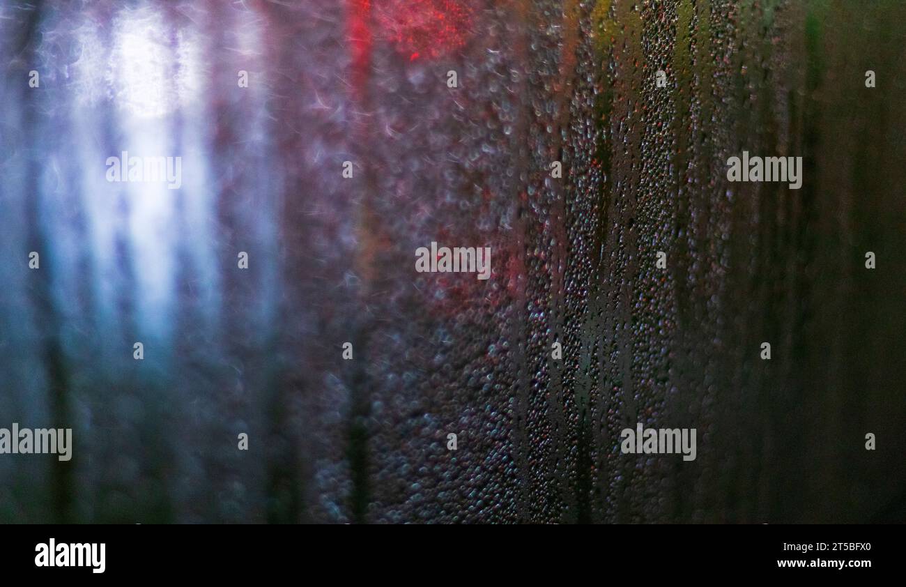 Shot of the window with blurred lights on the background and ...