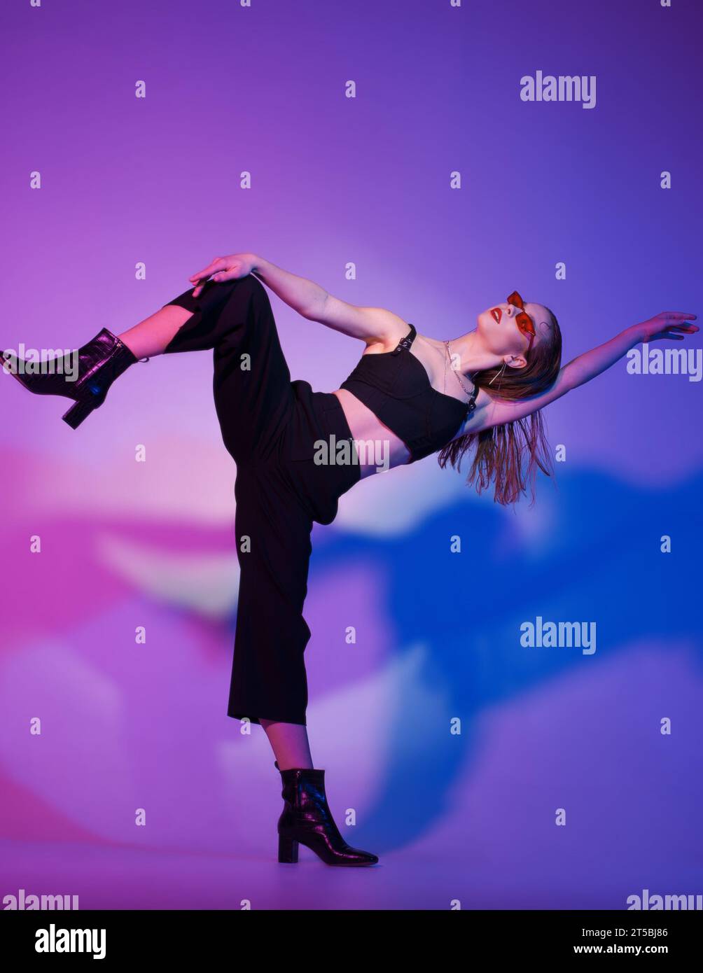 stylish girl with glasses dancing at a party at night Stock Photo - Alamy