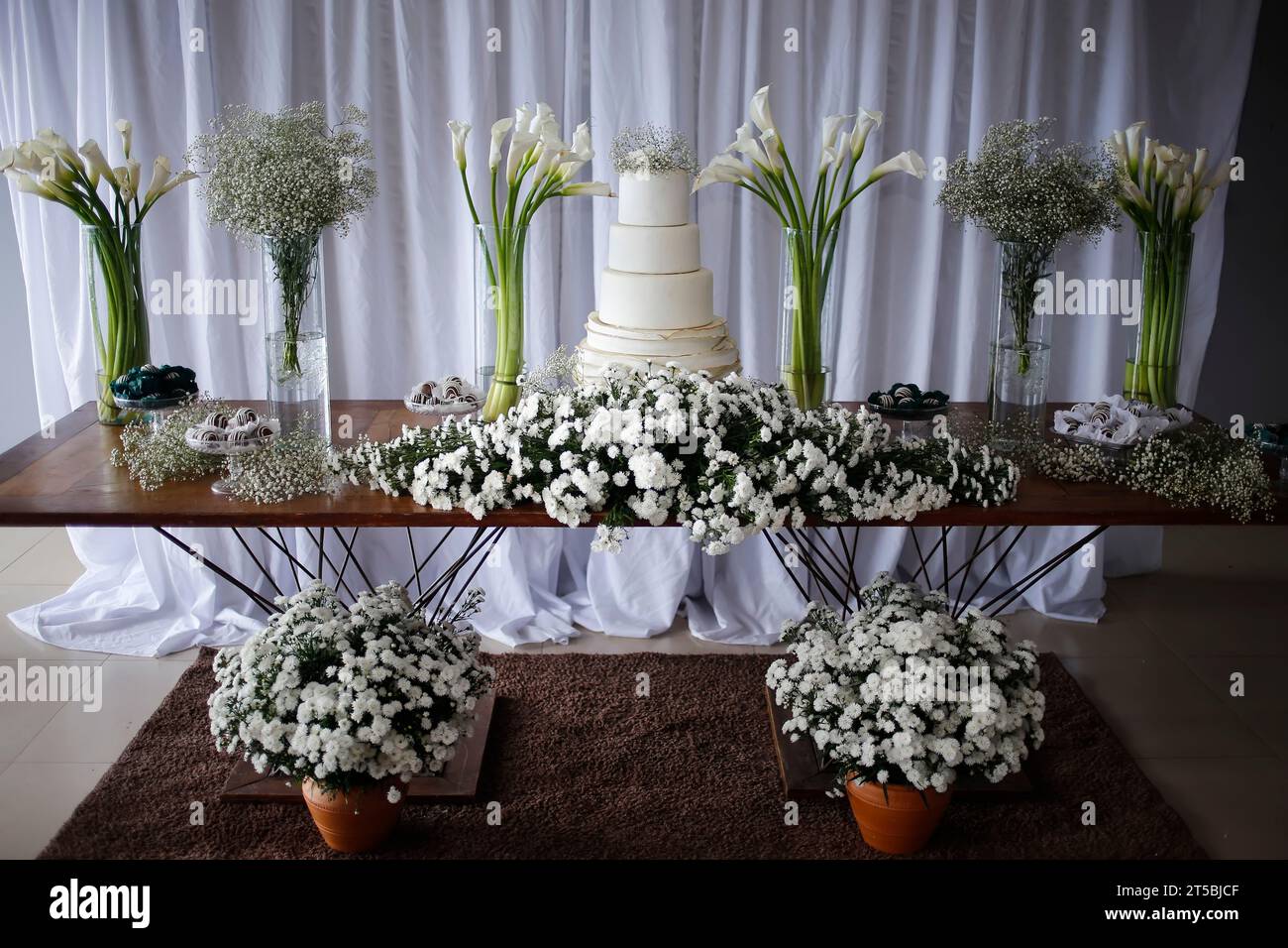 wedding table - elegant white table with cake and flowers decorated for ...