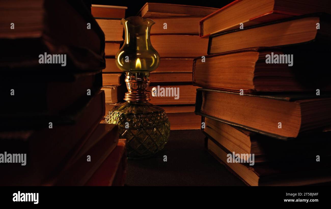 Gas lamp near stack of old books, slider footage in antique shop ...