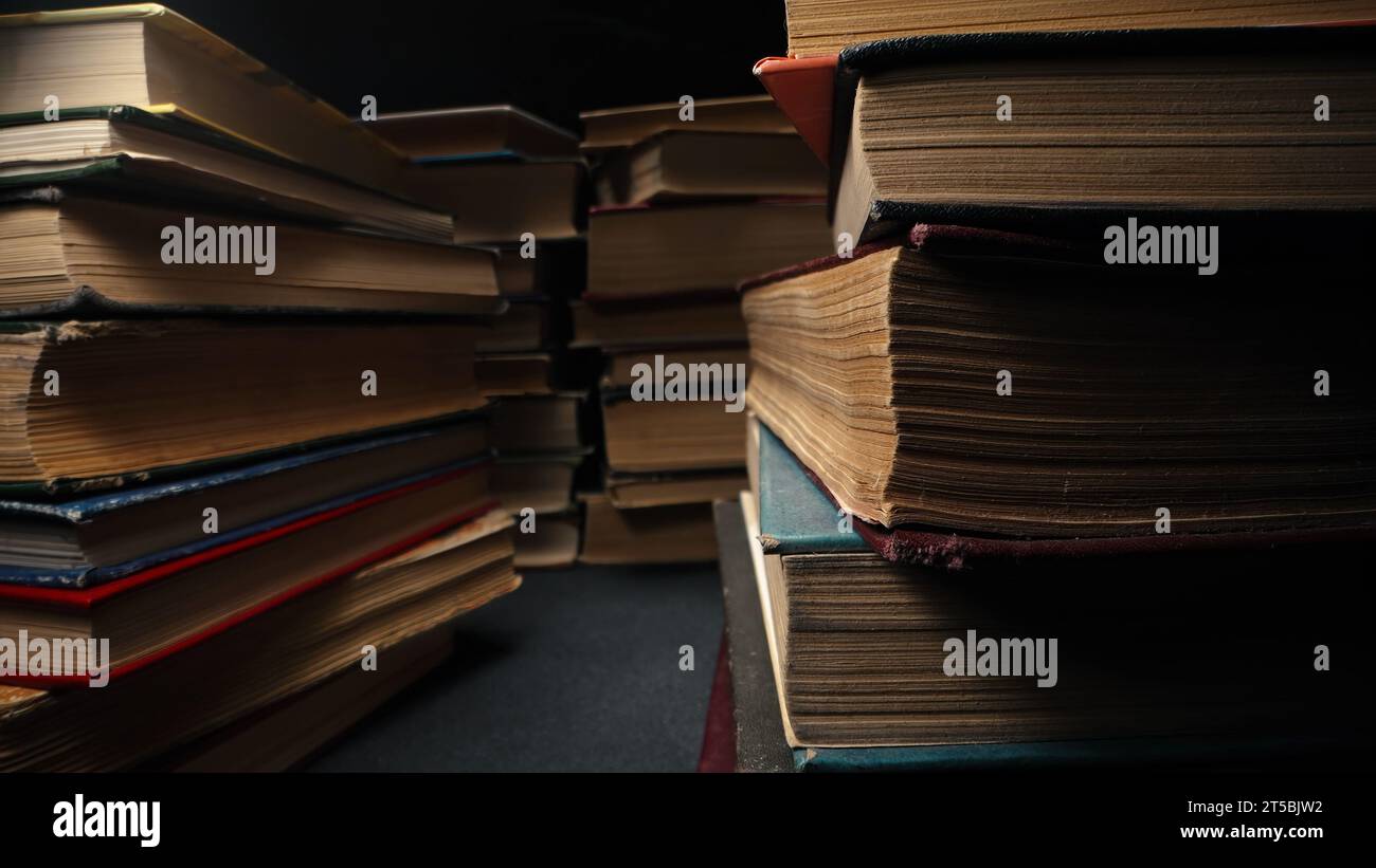 Library stack of old books, background of rows in antique shop ...