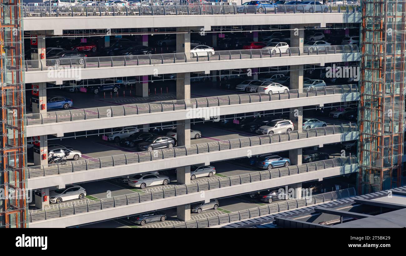 Multi-story car park building with cars. Airport carpark background ...