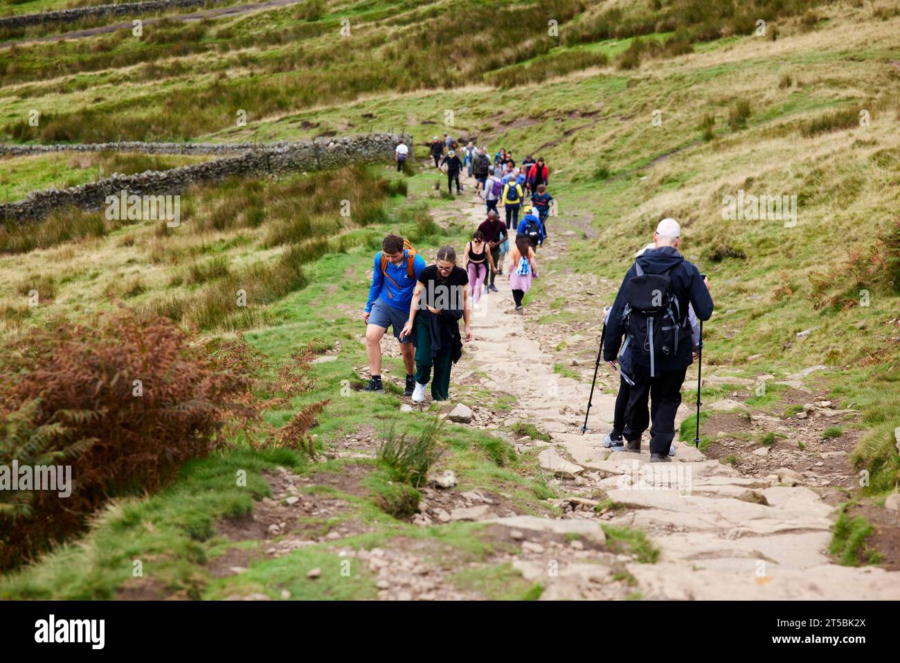 Walkers on the steep walkway up Pendle Hill east of Lancashire, England ...