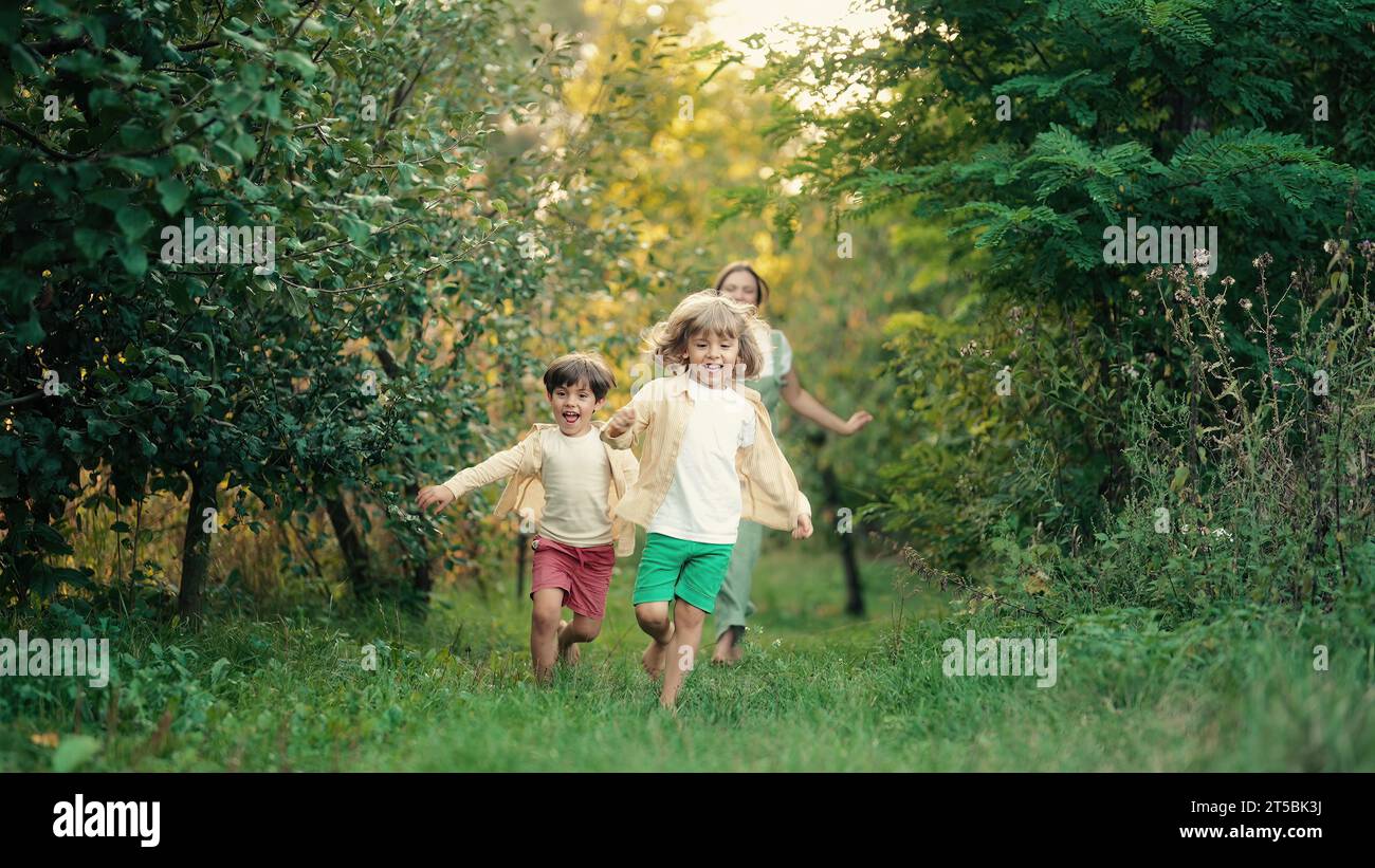 Kids playing running on plot in country house. Ecological life outside ...