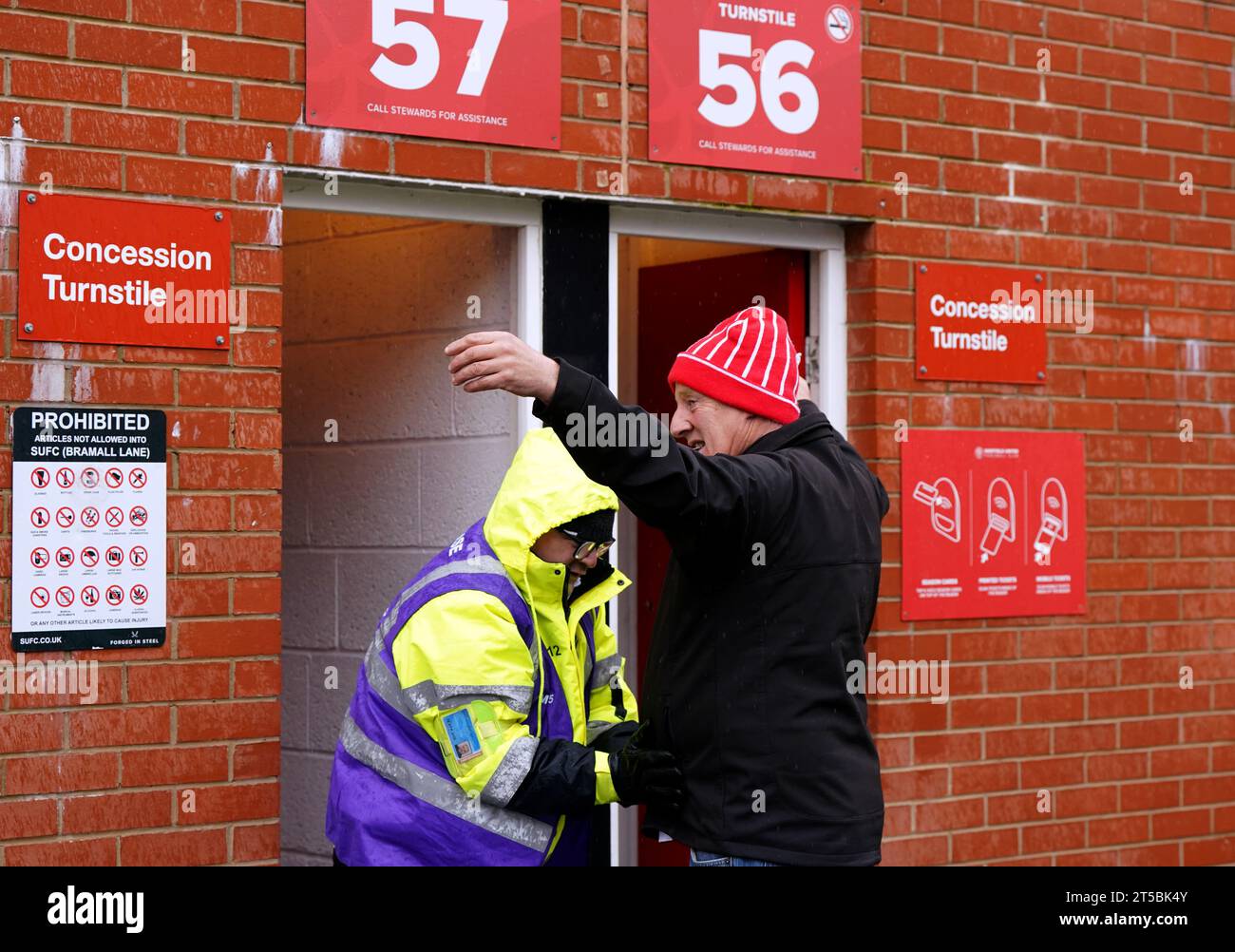 A Sheffield United fan is patted down by a match day steward ahead of ...