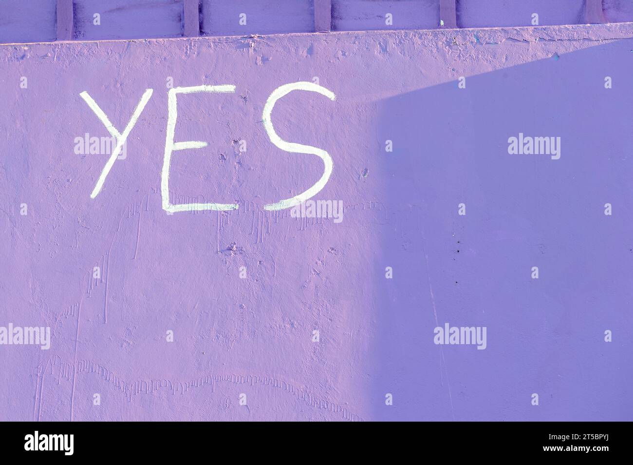 The word Yes spray-painted on a purple wall Stock Photo - Alamy