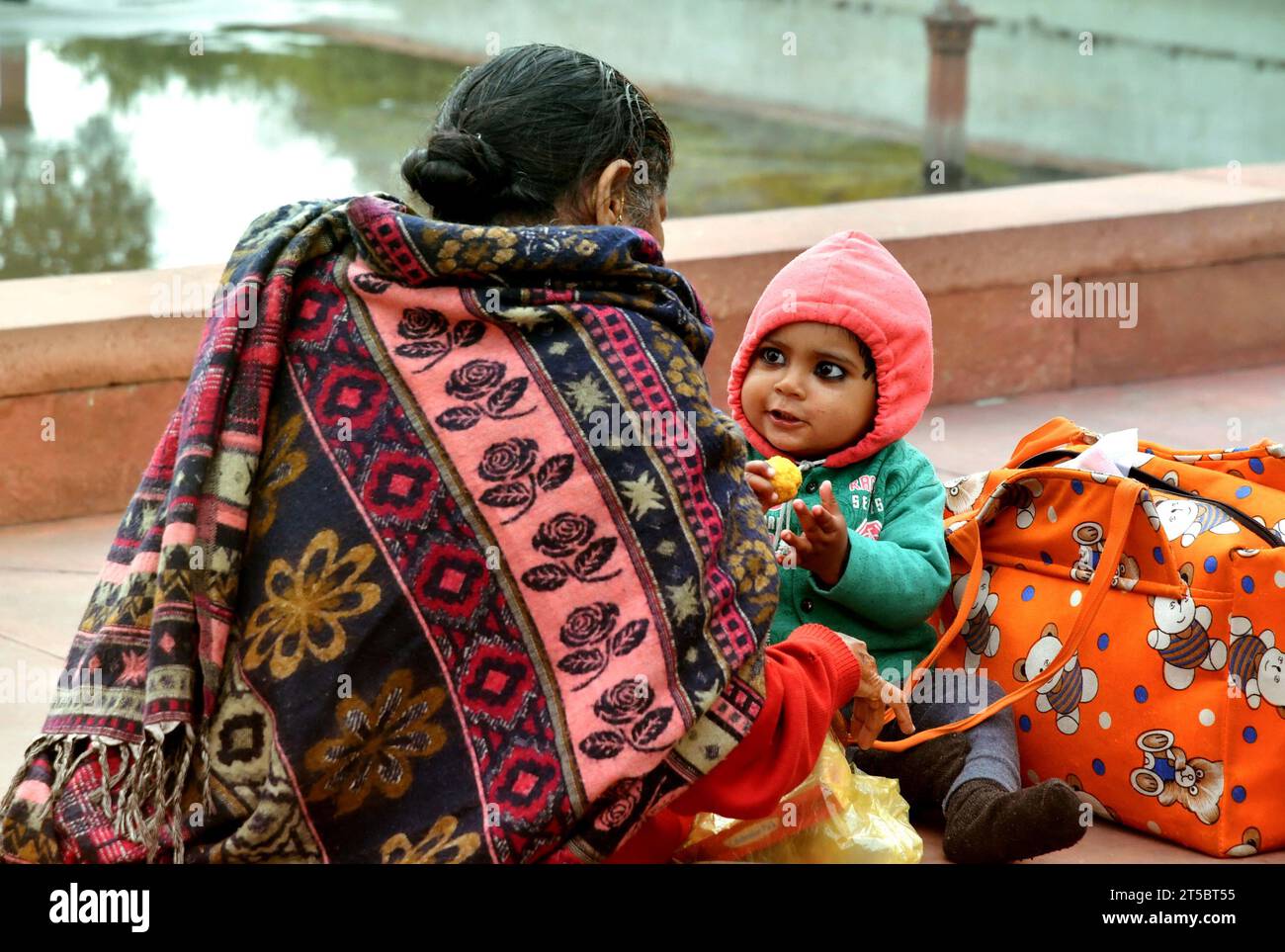 New Delhi, India - November 13, 2022: Poor Indian woman sitting with a ...
