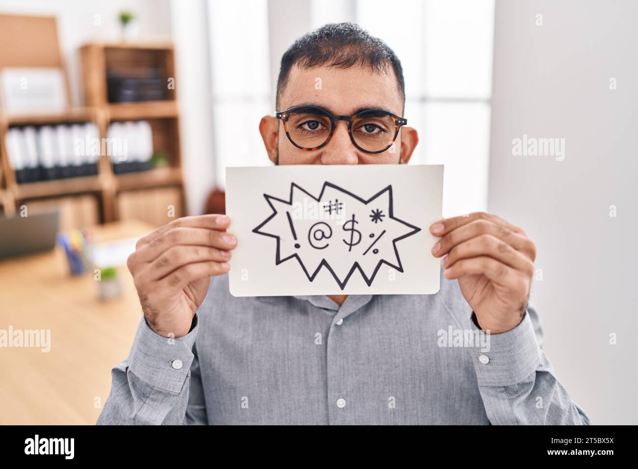 Middle east man with beard holding banner with swear words smiling with ...