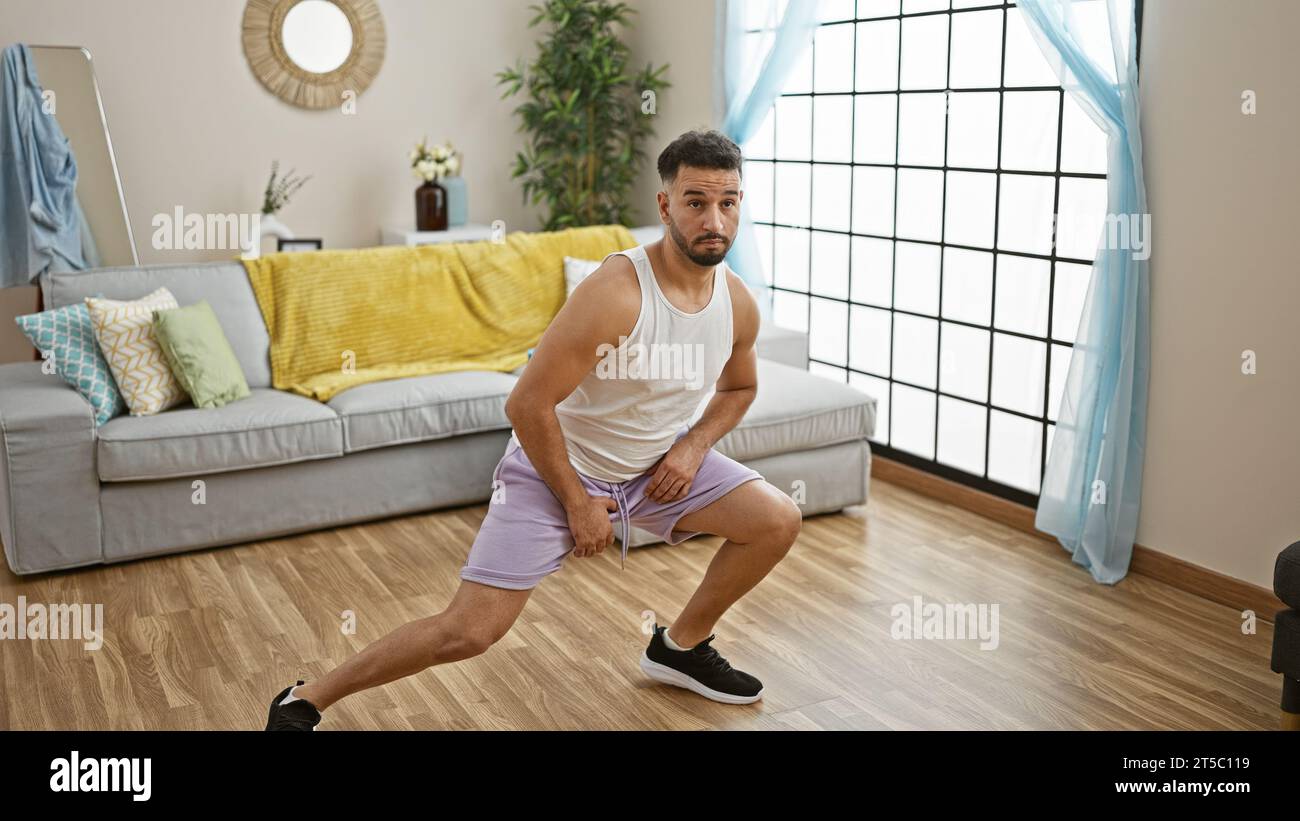 Young arab man training legs exercise at home Stock Photo - Alamy