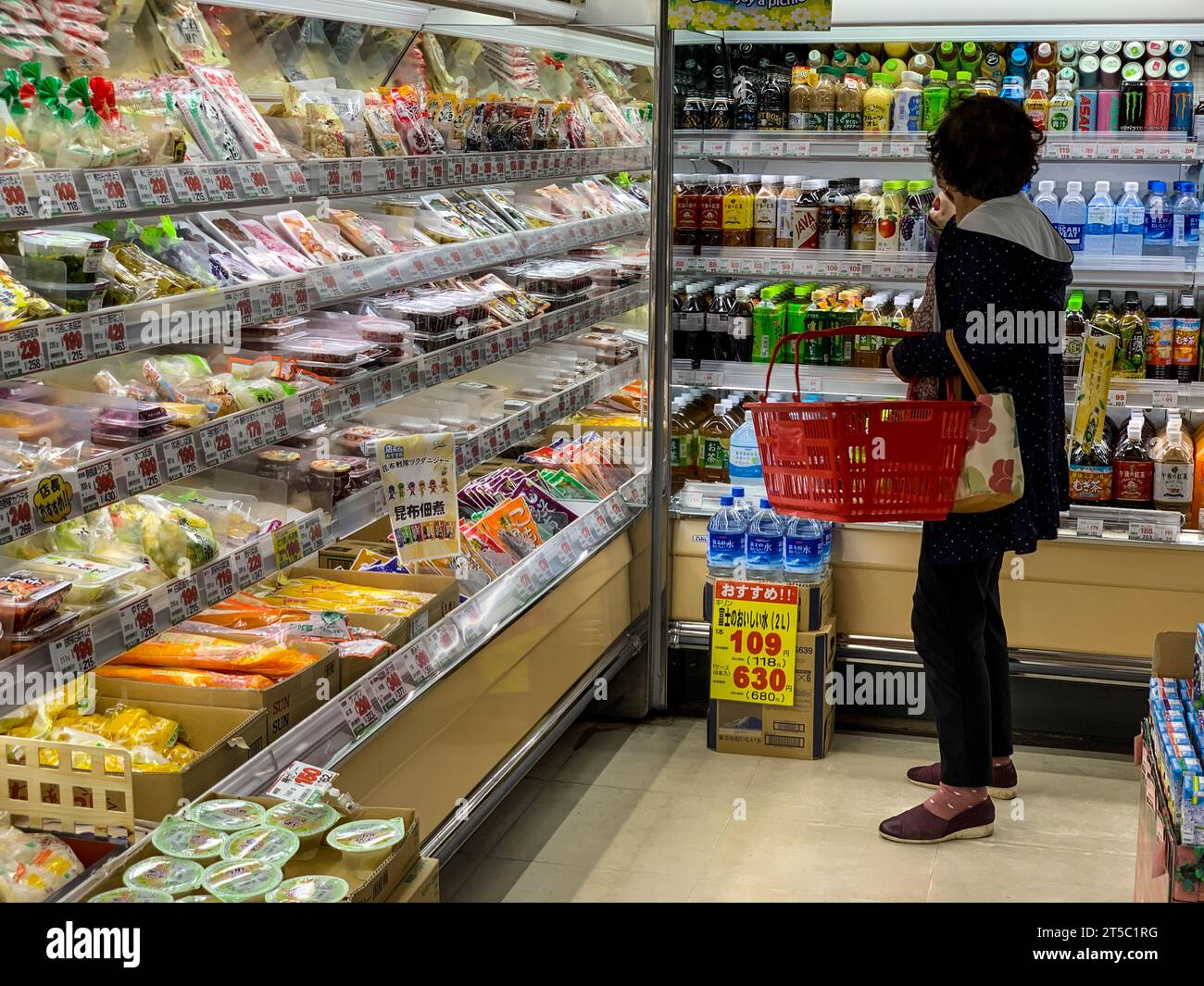 Japan, Kyushu, Imi. Small Grocery Store, Shopper Selecting Beverage ...