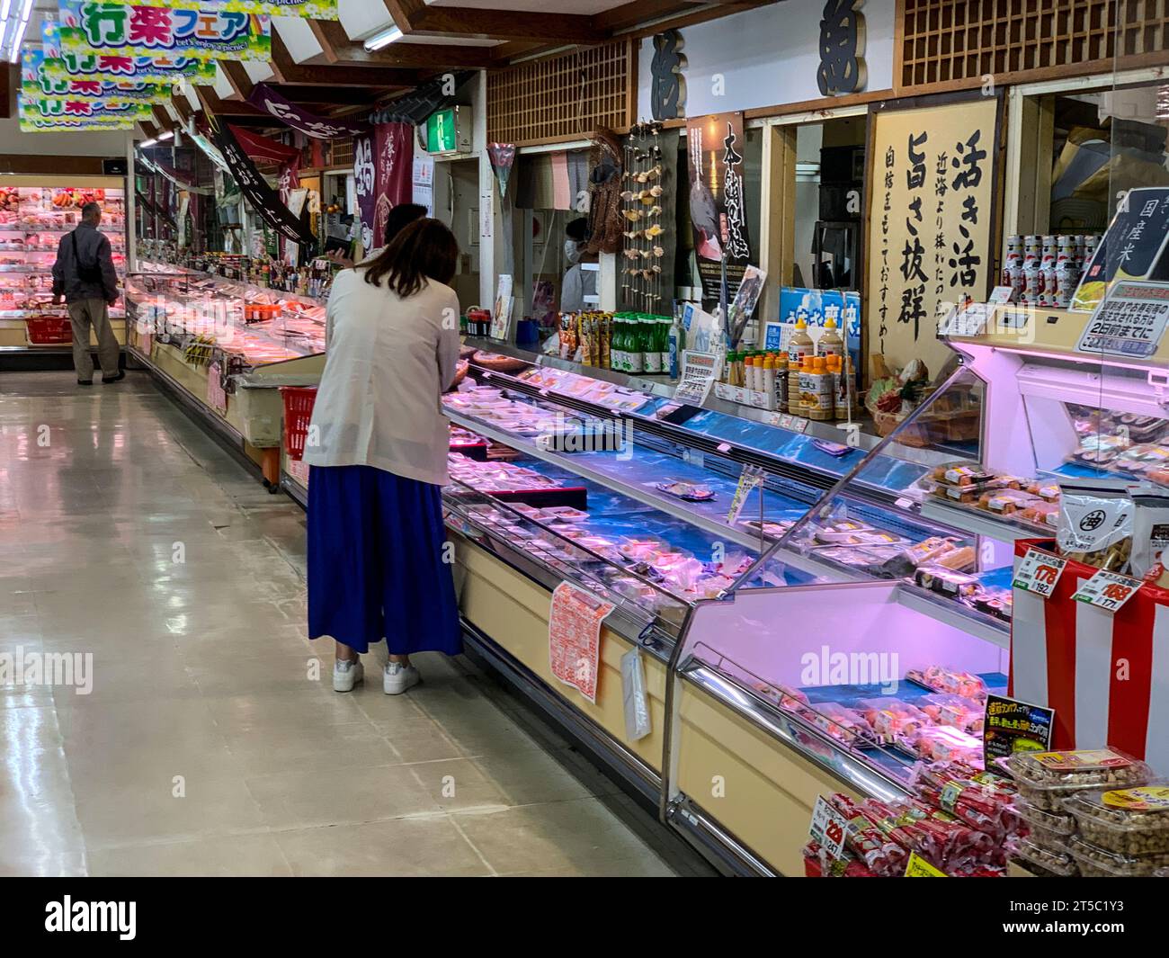 Japan, Kyushu, Imi. Small Grocery Store, Shoppers Examining Meat and ...