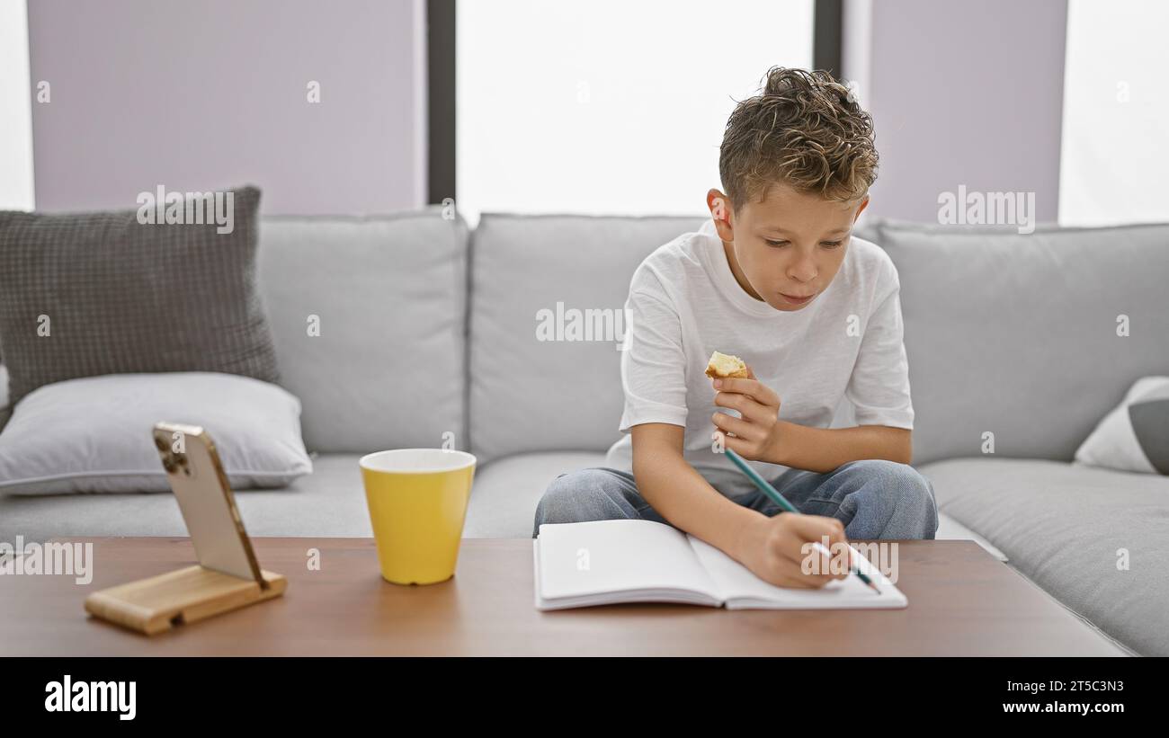 Adorable blond boy seriously taking notes on phone, indulging in sweet ...