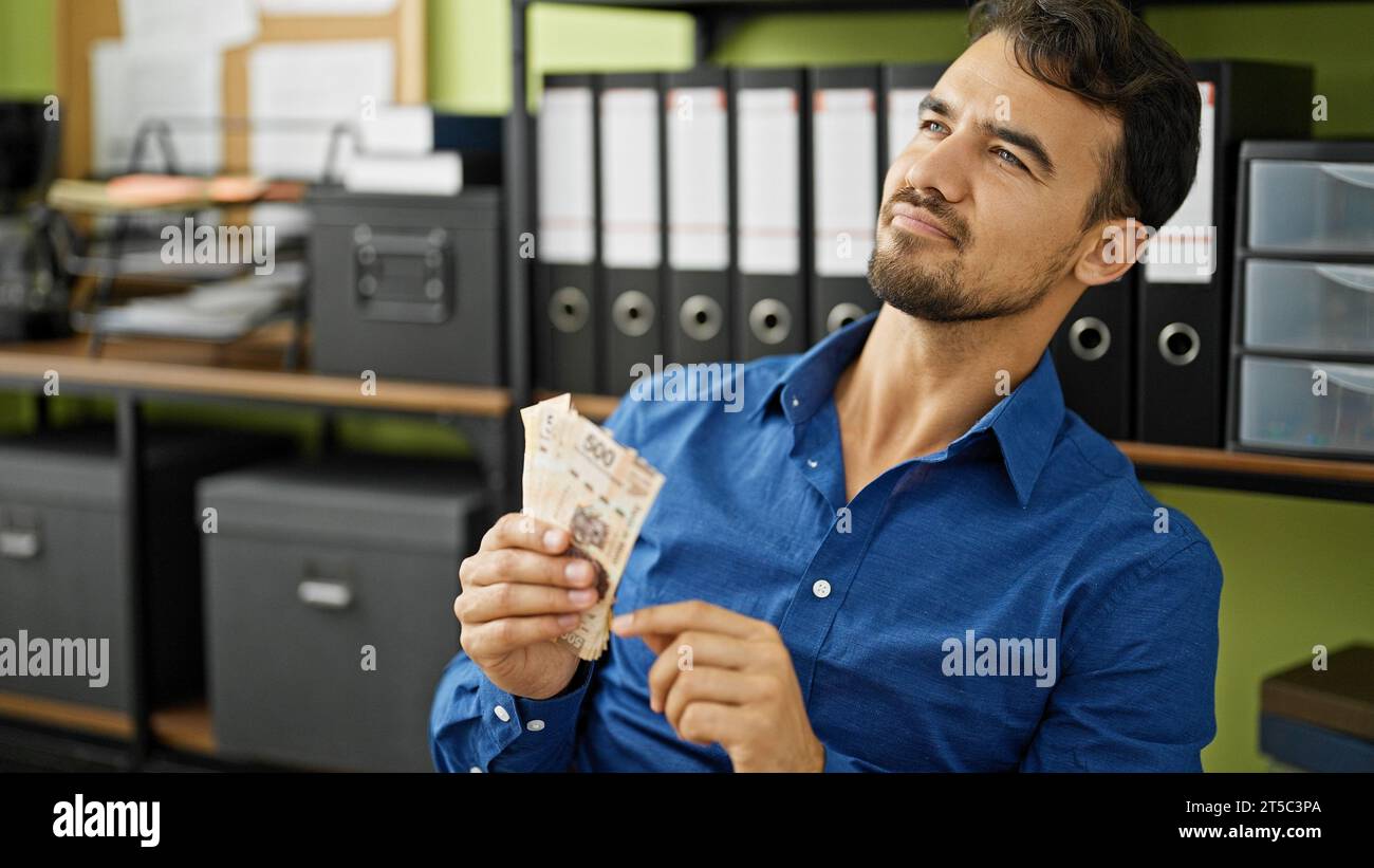 Smiling man counting money workplace hi-res stock photography and ...