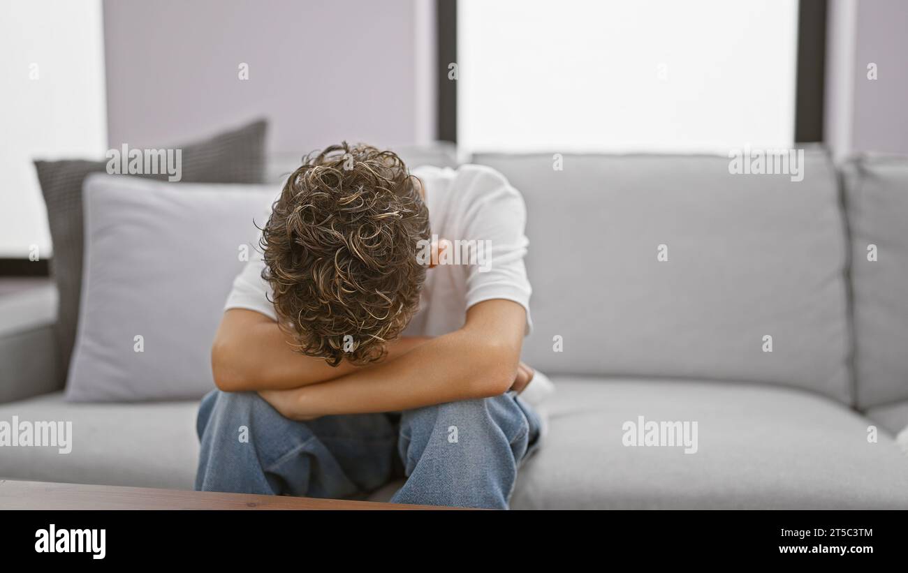 Adorable blond boy crying on sofa, unhappy child struggling with ...