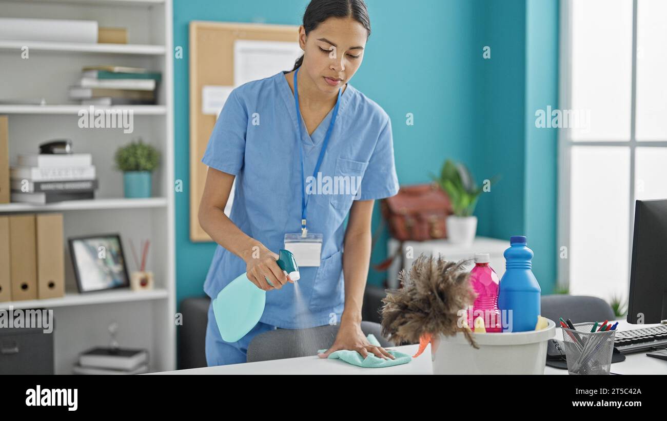 African american woman professional cleaner cleaning table at the ...