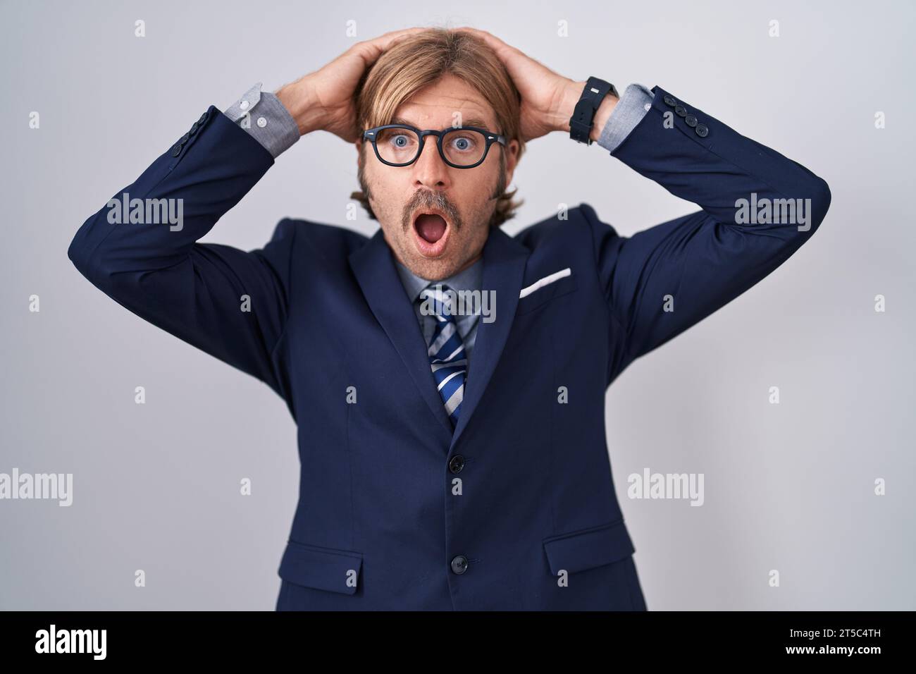 Caucasian man with mustache wearing business clothes crazy and scared ...