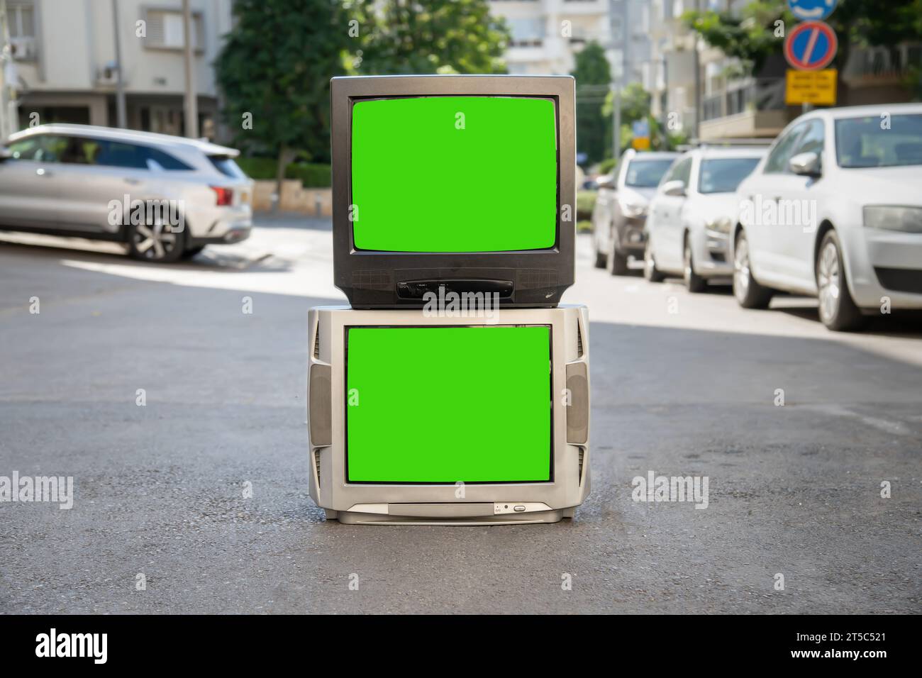 Two Old TV sets with a green screens on the city street with cars Stock ...
