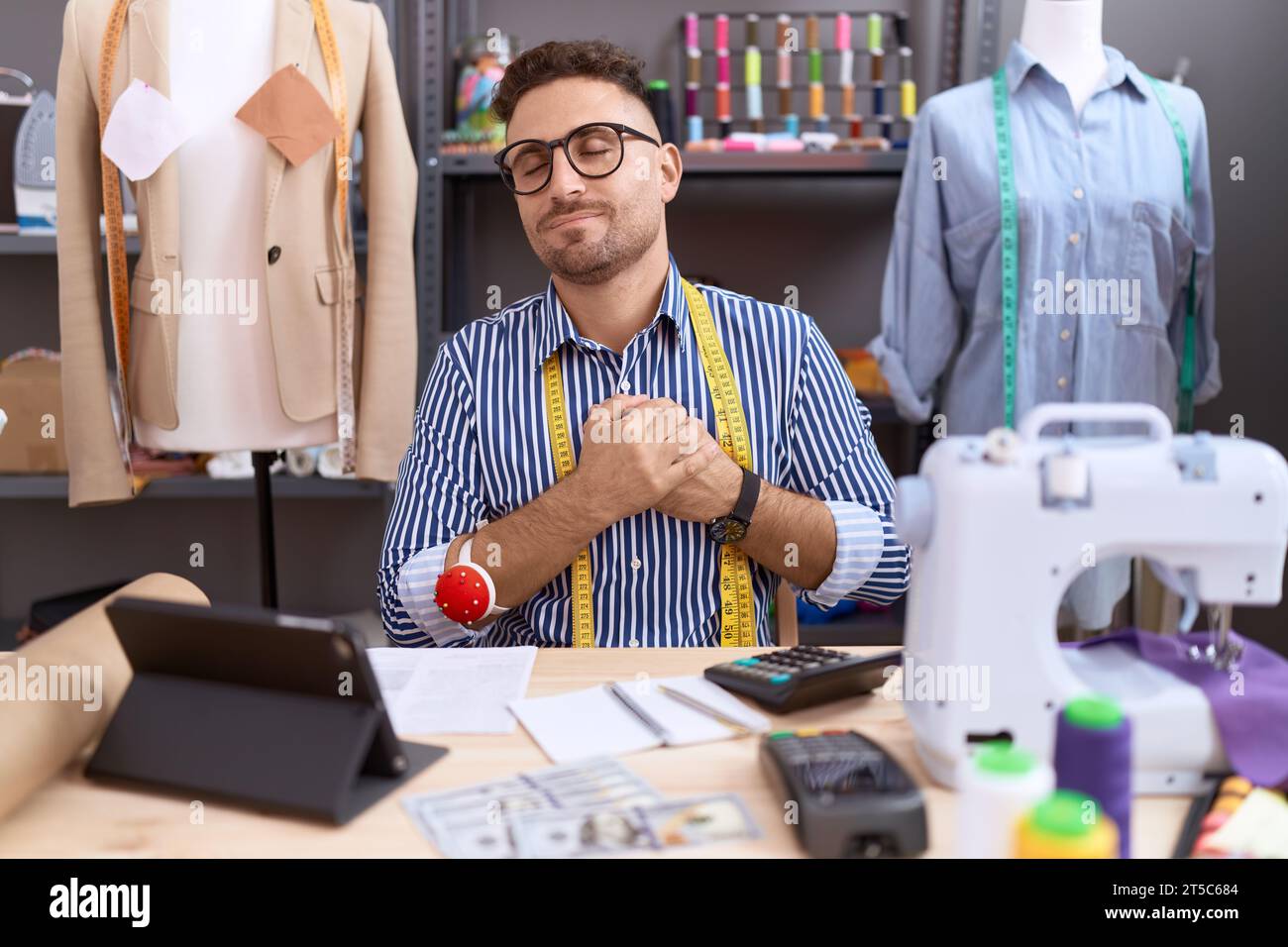Hispanic man with beard dressmaker designer working at atelier smiling ...