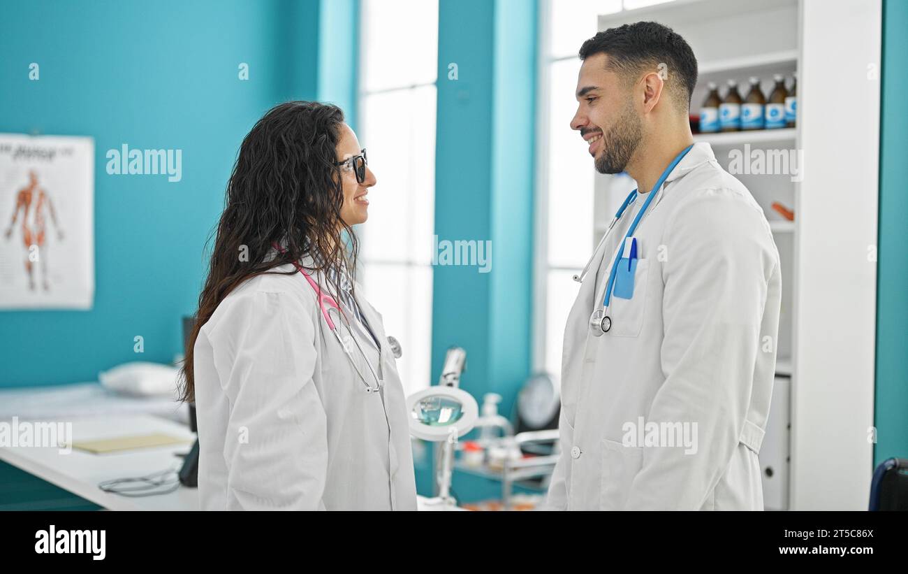 Man and woman doctors standing together speaking at the clinic Stock ...