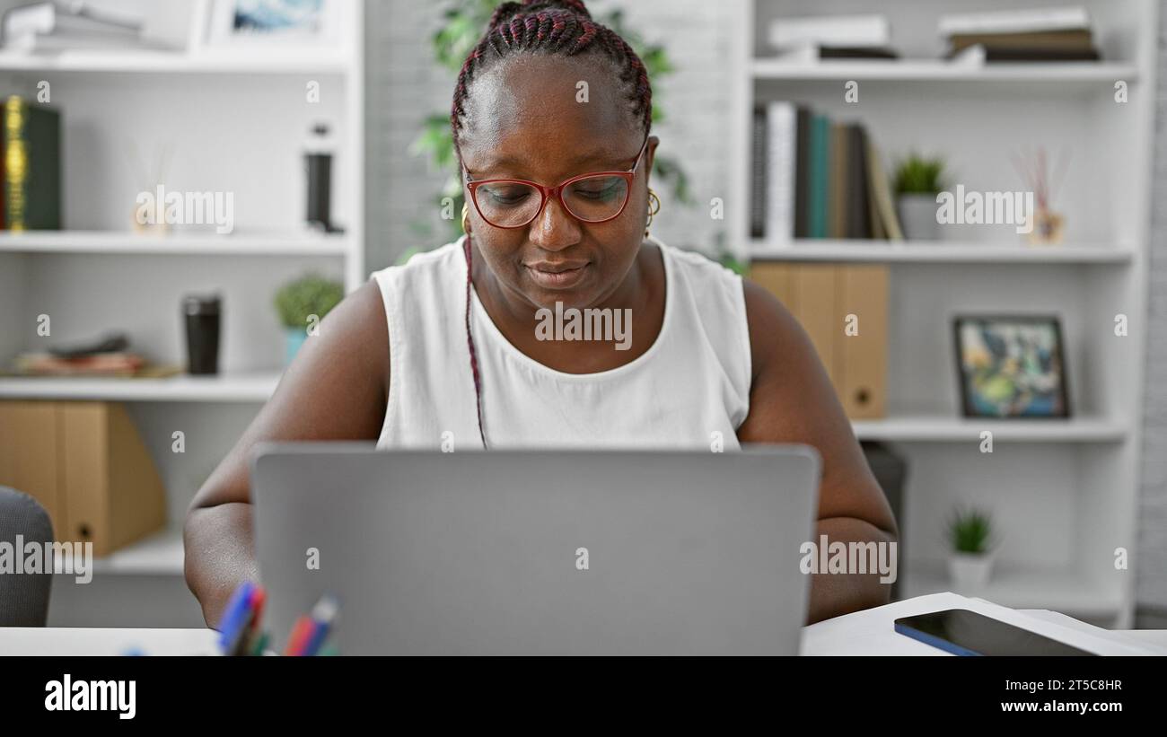 Focused african american woman worker excelling in business. working ...