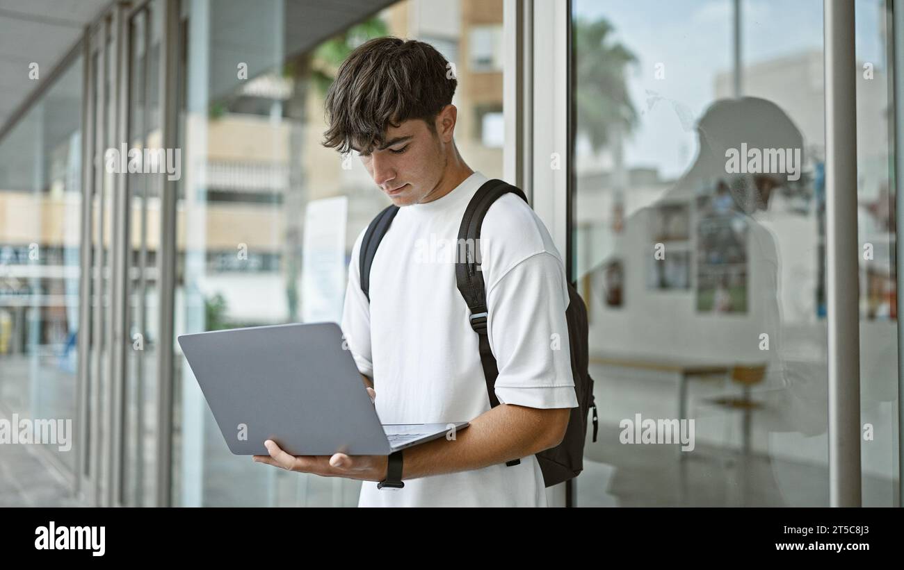 Cool hispanic teen guy, a smart university student, chilling outdoors ...