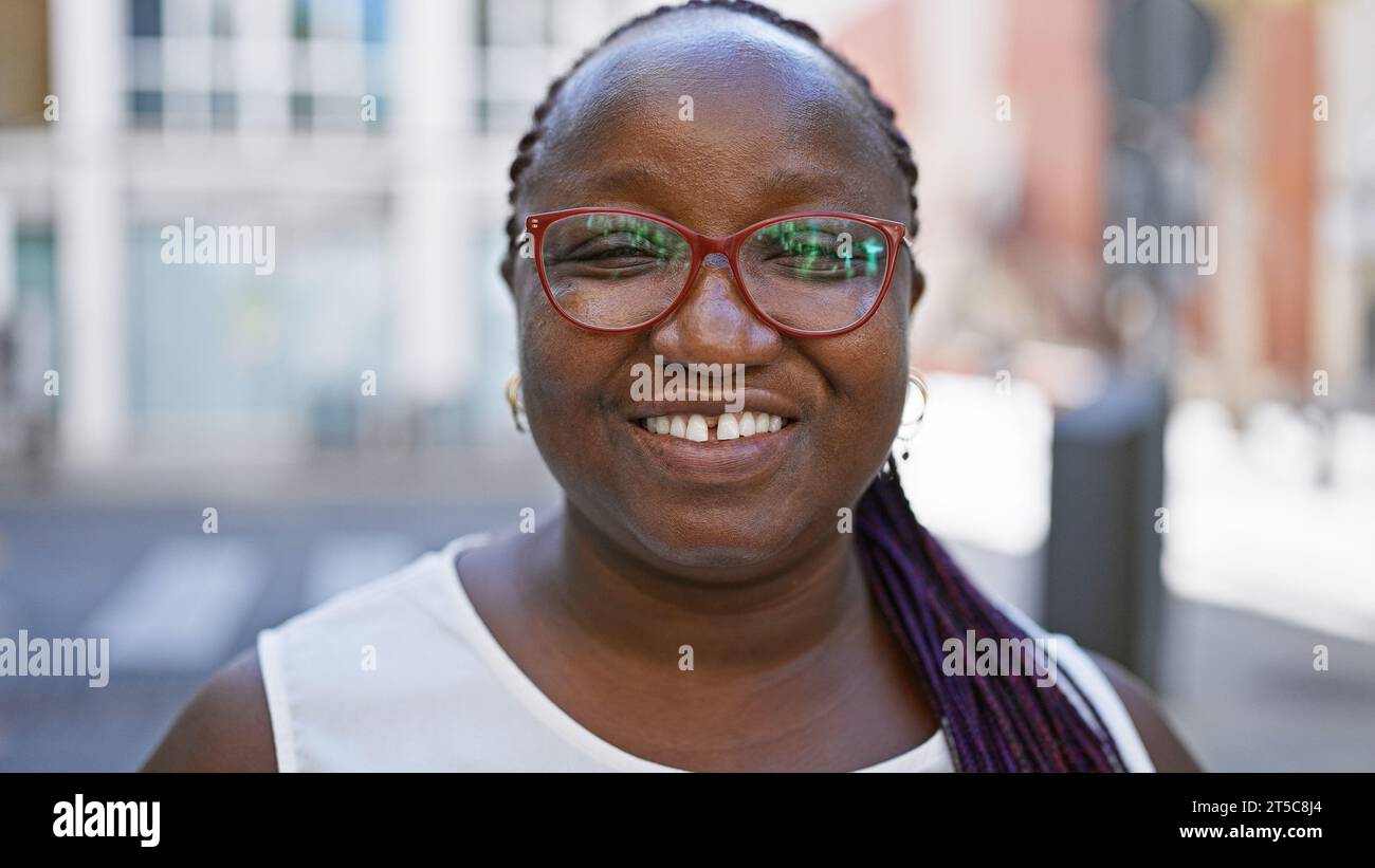Confident african american woman standing on urban street, radiating ...