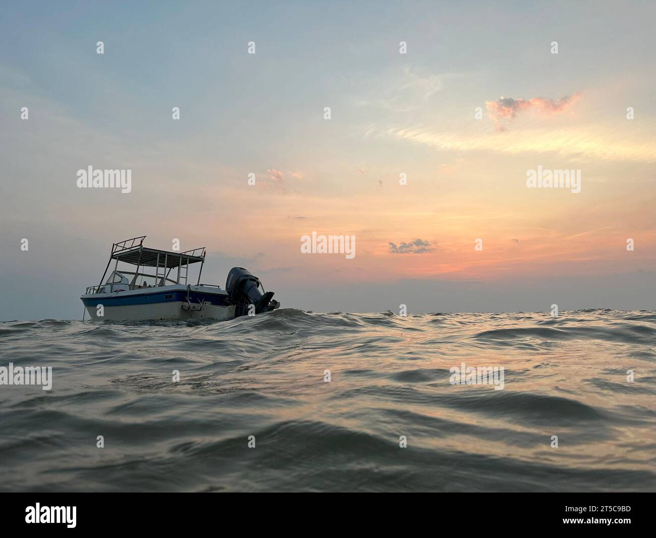 Motor ship at sunset in Thailand Stock Photo - Alamy