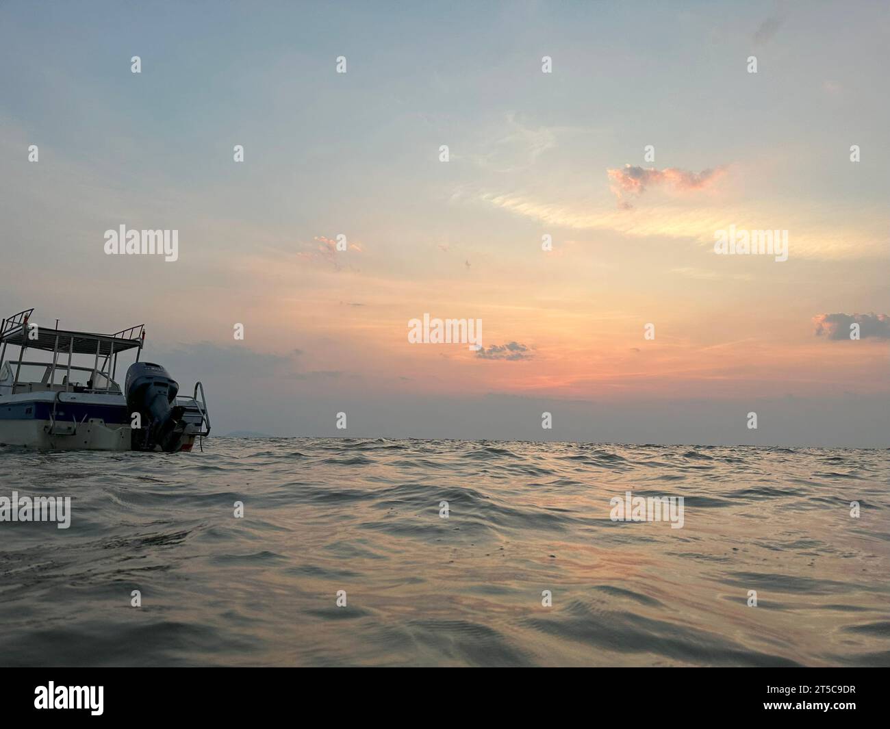 Motor ship at sunset in Thailand Stock Photo - Alamy