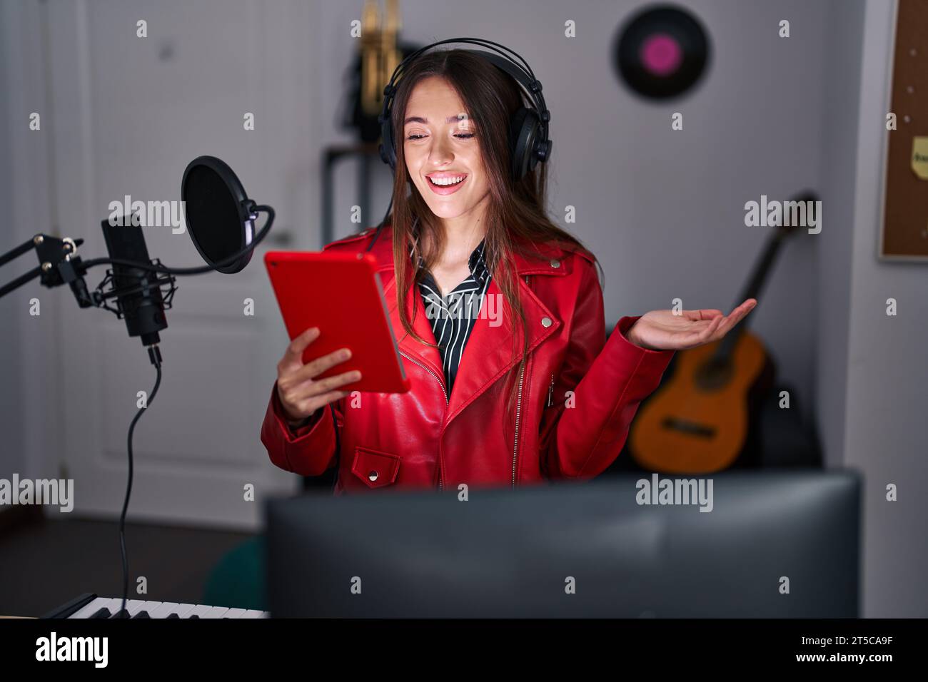 Young brunette woman singing song using microphone celebrating ...