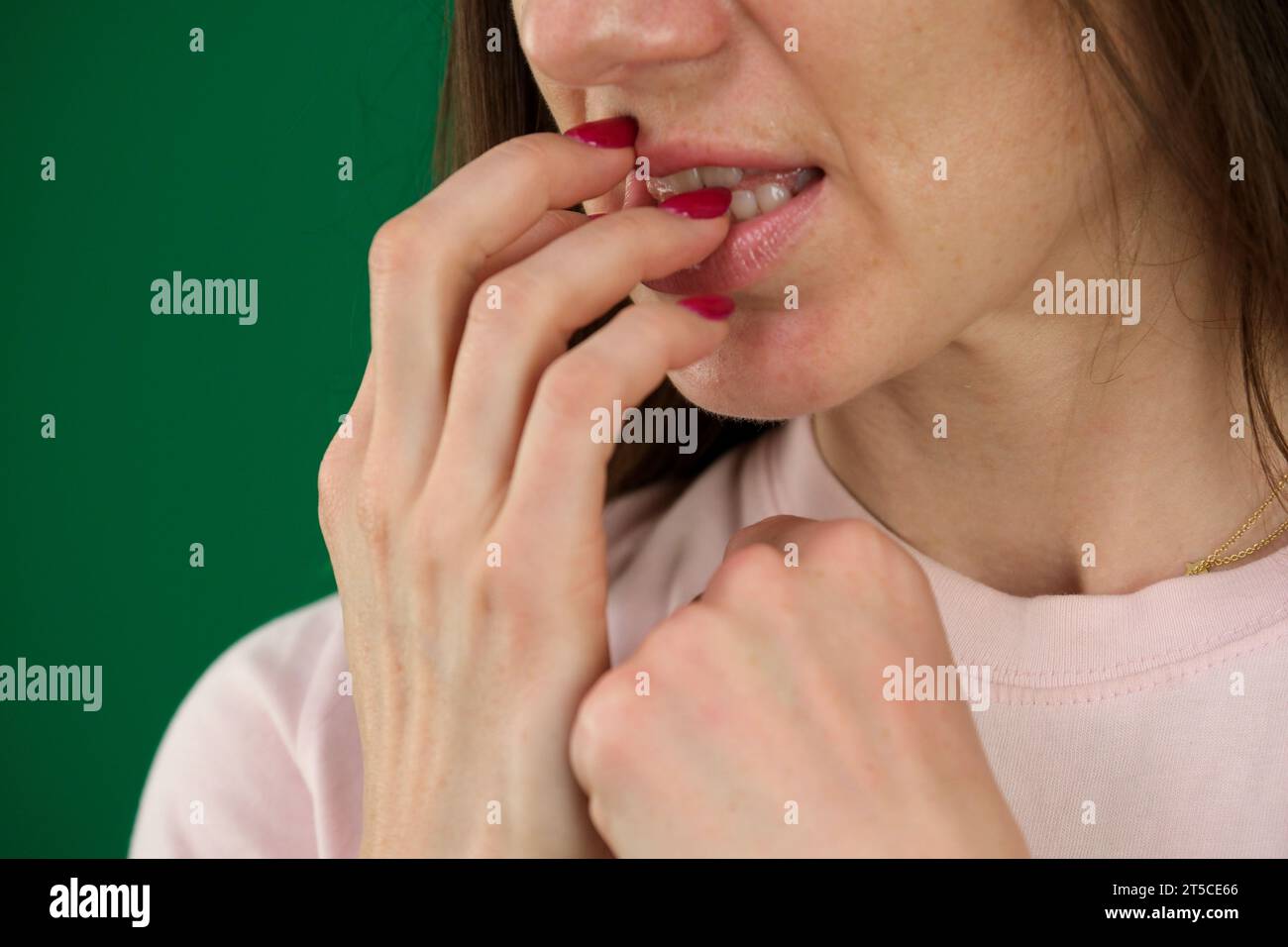 biting your nails different emotions of a young girl on a green ...