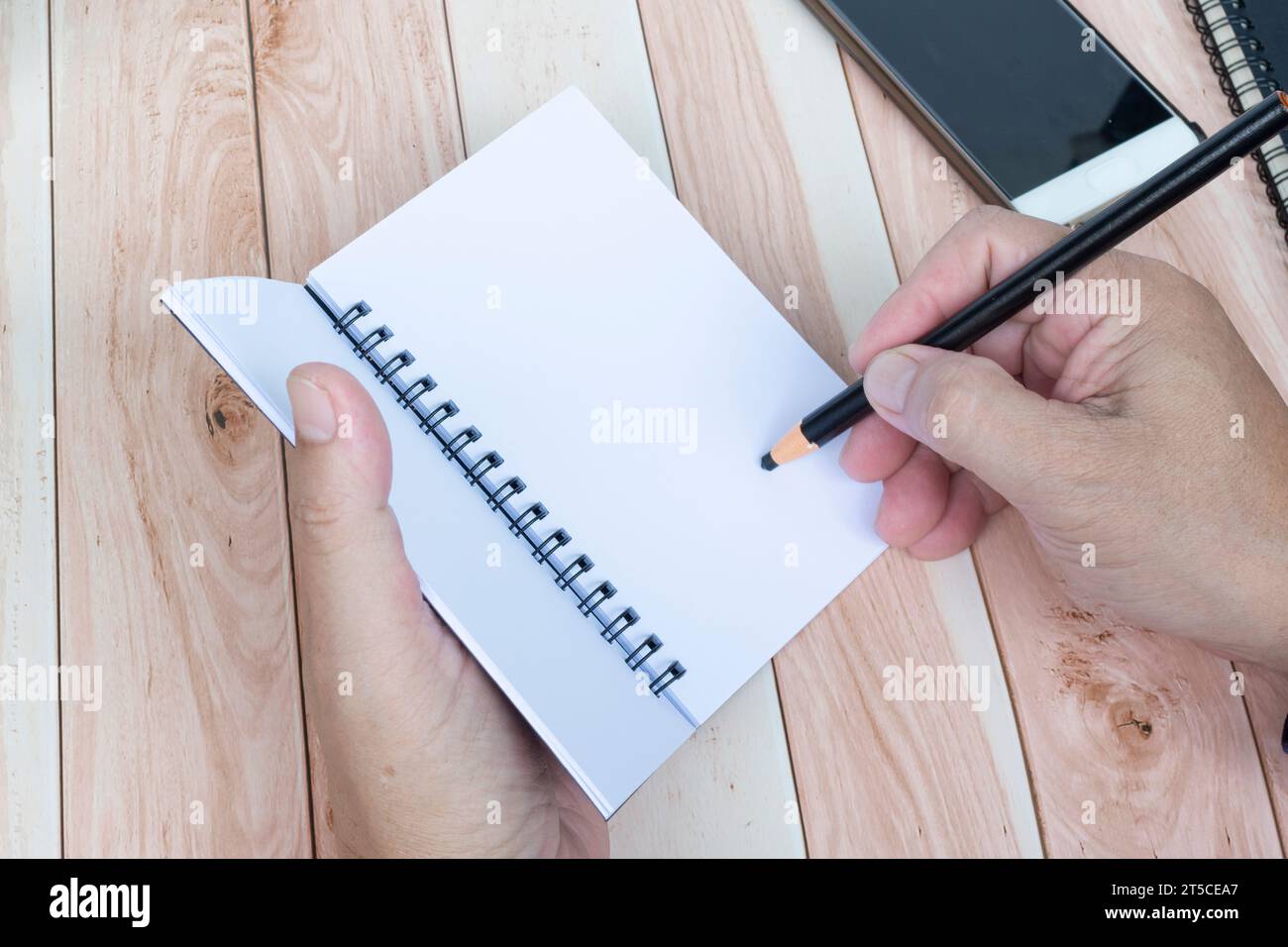 Businessman hands with pen writing notebook on office desk. Copy space ...