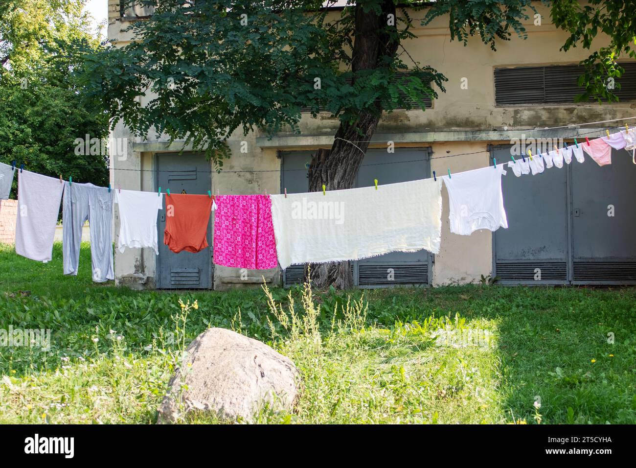 Clothes are drying on a line in the yard close up Stock Photo - Alamy
