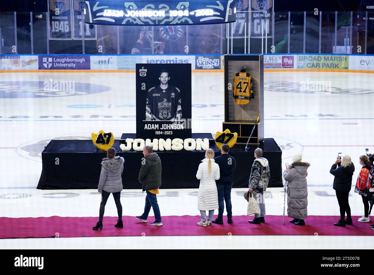 People queue to sign a book of condolence as they attend a memorial for ...