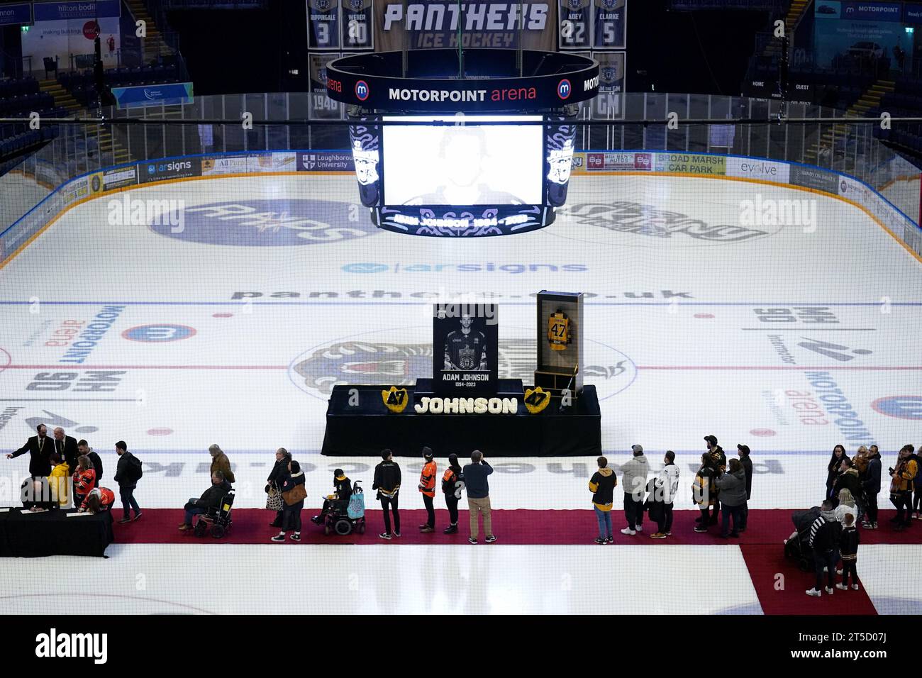 People queue to sign a book of condolence as they attend a memorial for ...