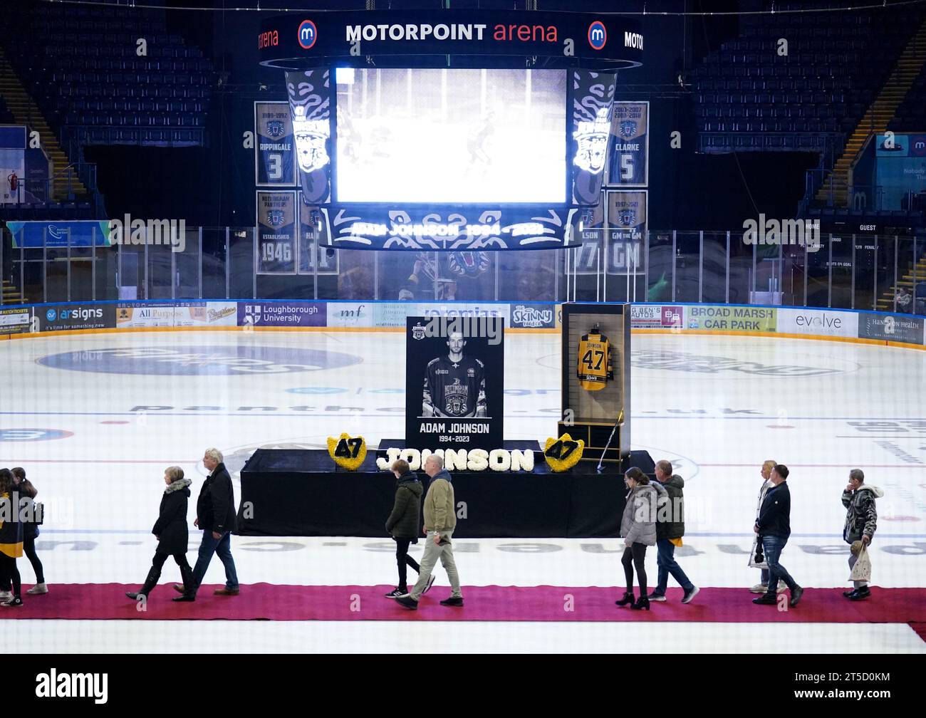 People queue to sign a book of condolence as they attend a memorial for ...
