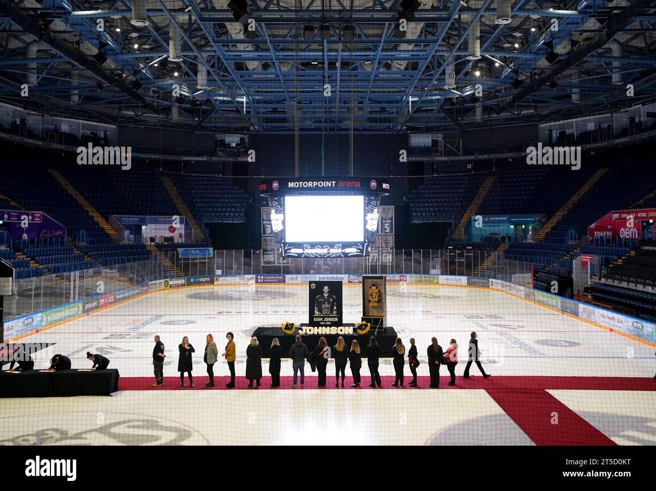 People queue to sign a book of condolence as they attend a memorial for ...