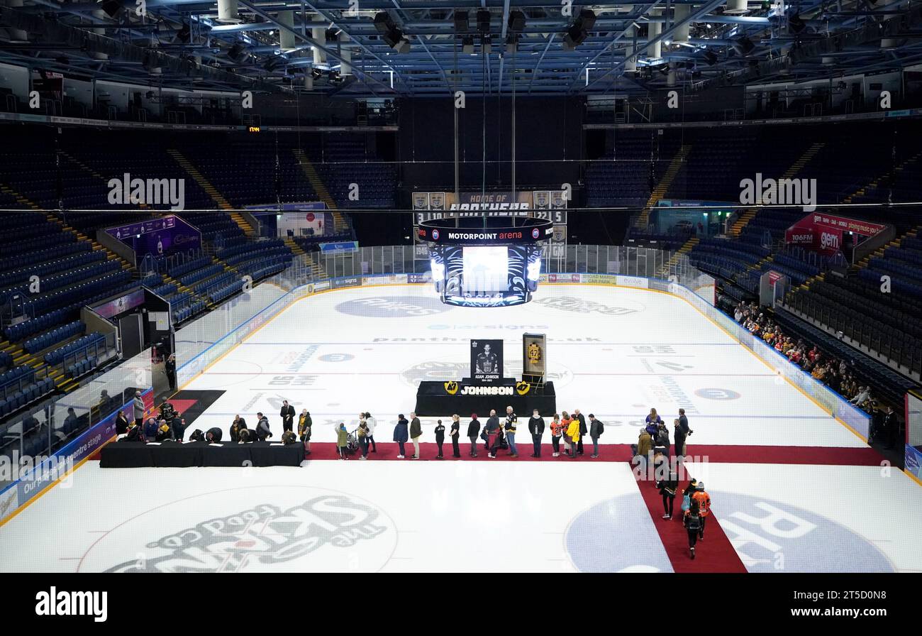 People queue to sign a book of condolence as they attend a memorial for ...