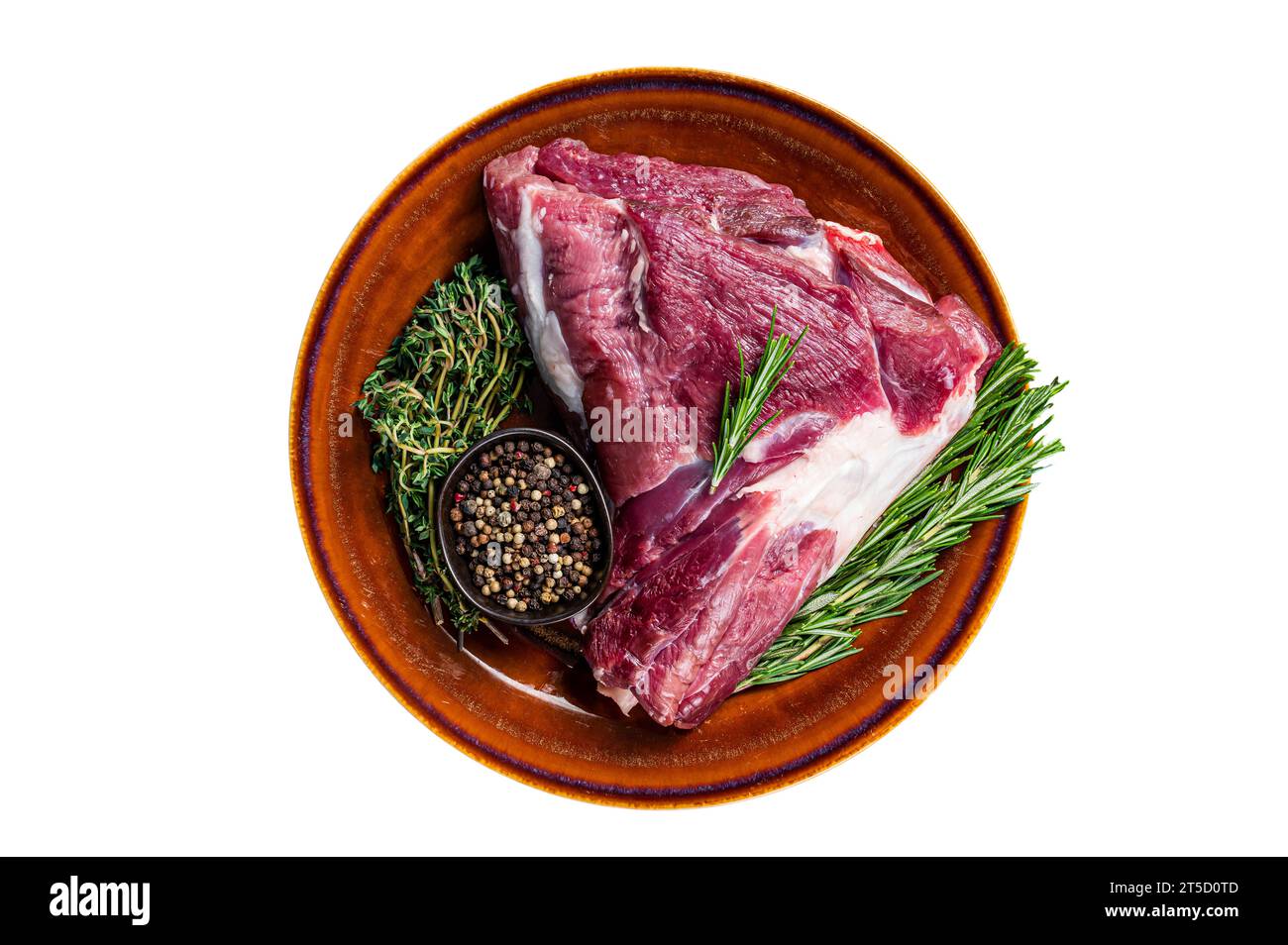 Uncooked Raw goat thigh or leg with rosemary and thyme in rustic plate ...