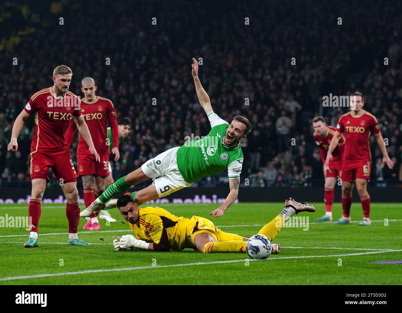 Hibernian's Dylan Vente and Aberdeen goalkeeper Kelle Roos in action during the Viaplay Cup semi ...