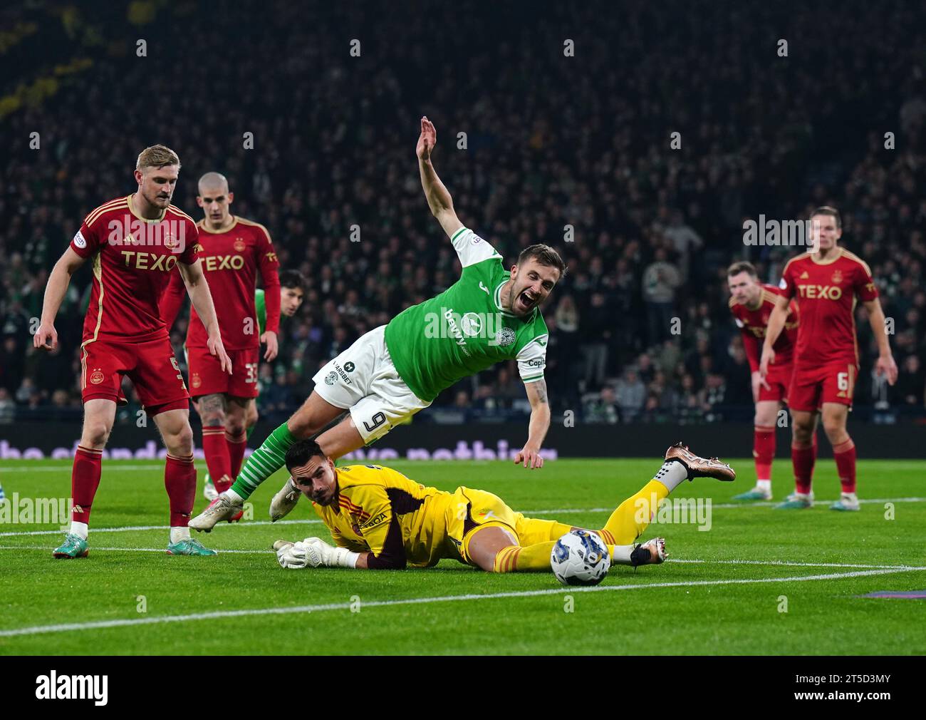 Hibernian's Dylan Vente and Aberdeen goalkeeper Kelle Roos in action ...