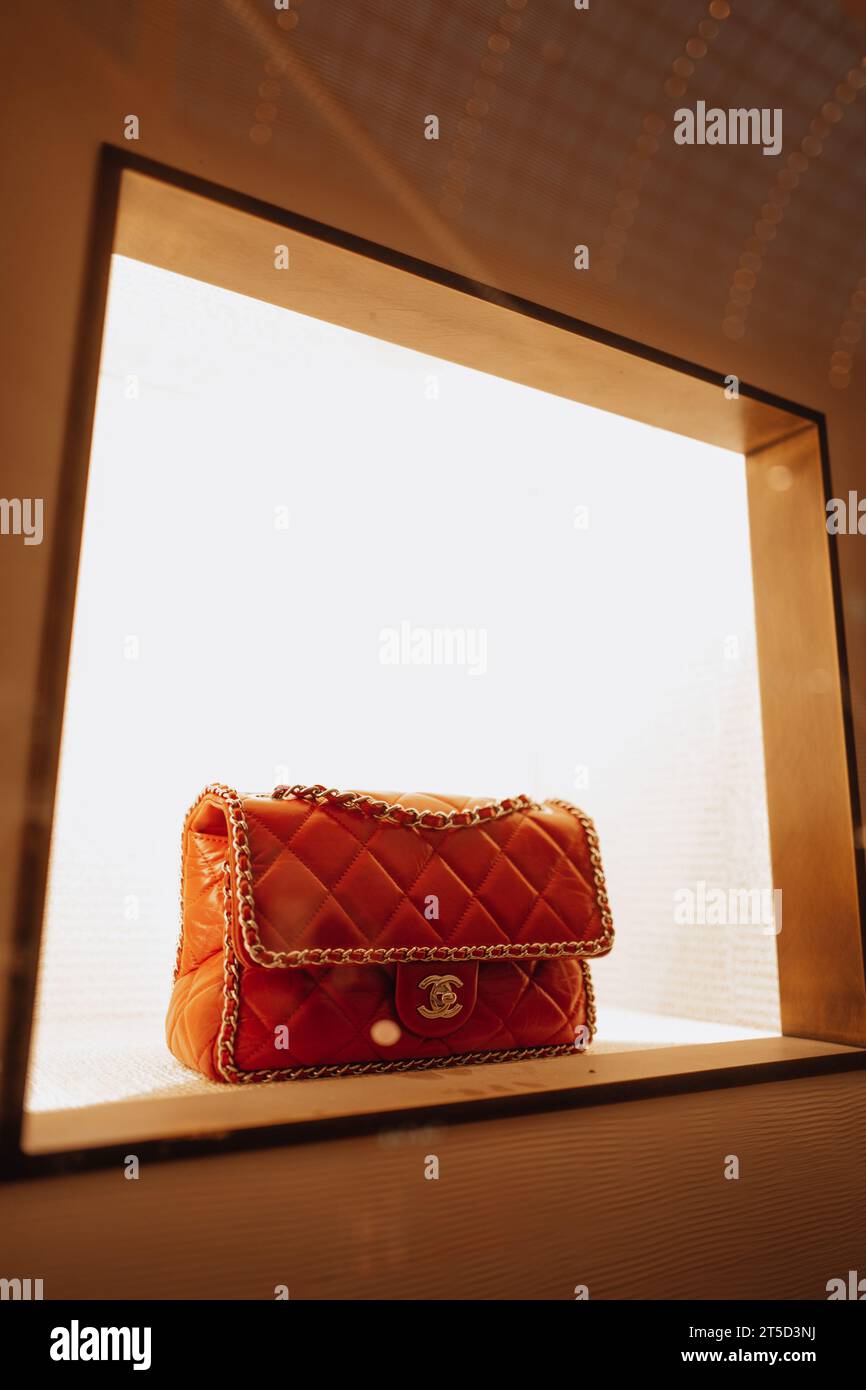 Classy red female Chanel handbags with golden chain in the window of a ...