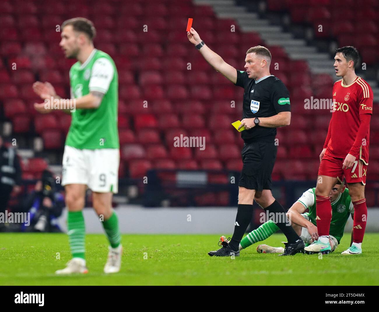 Referee John Beaton shows a red card to Aberdeen's Jack Mackenzie ...