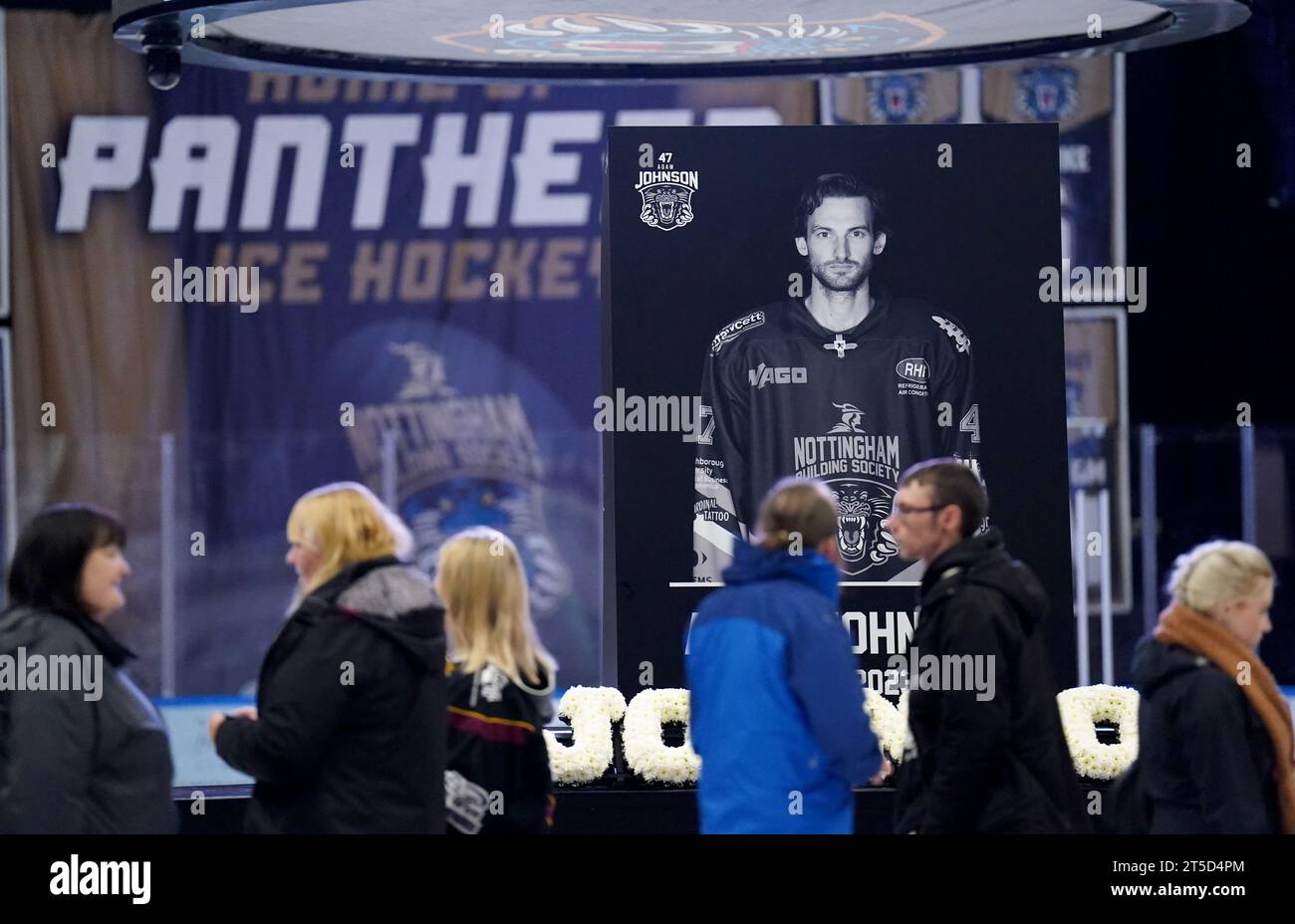People queue to sign a book of condolence as they attend a memorial for ...
