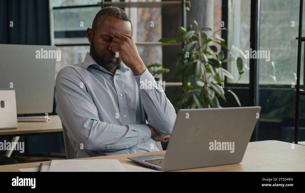 African man headache typing on hi-res stock photography and images - Alamy