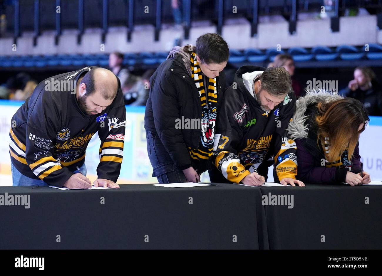 People sign a book of condolence as they attend a memorial for ...