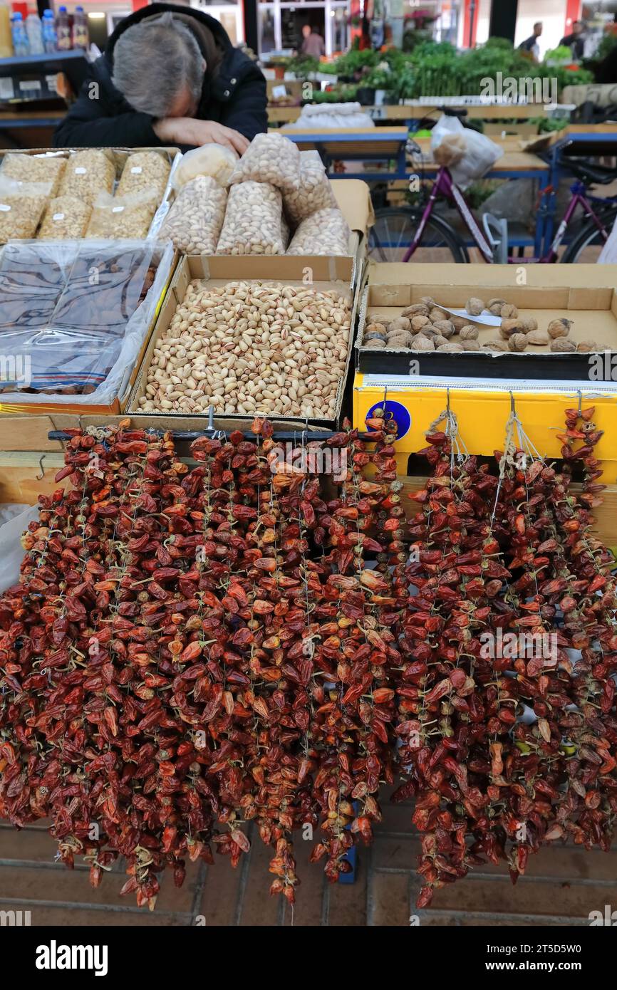 006 Sleeping vendor at a market stall selling peanuts-figs-pistachios ...